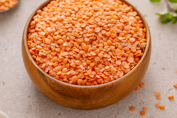 Red lentils raw in a bowl ready to be cooked Stock Photo by fahrwasser