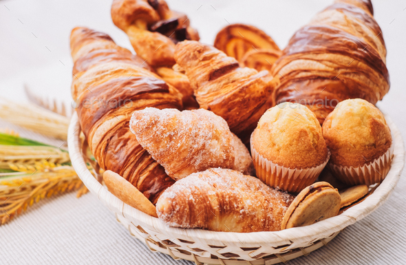Sweet bakery products and croissant in the basket captured from above ...