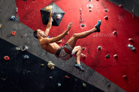 Panoramic man bouldering at an indoor climbing centre. Stock Photo by ...