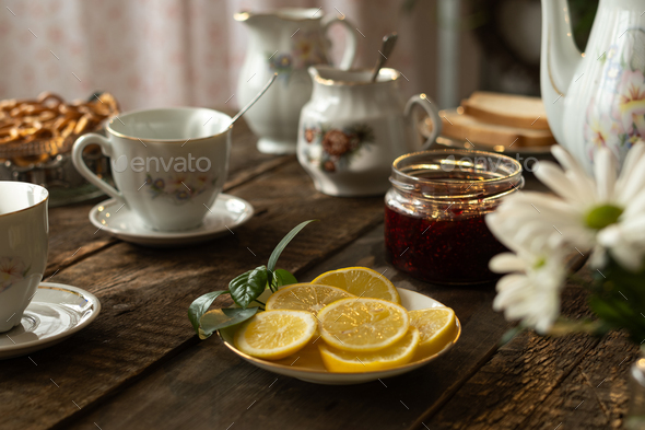 Table set for morning breakfast with tea. Stock Photo by Meteoritka