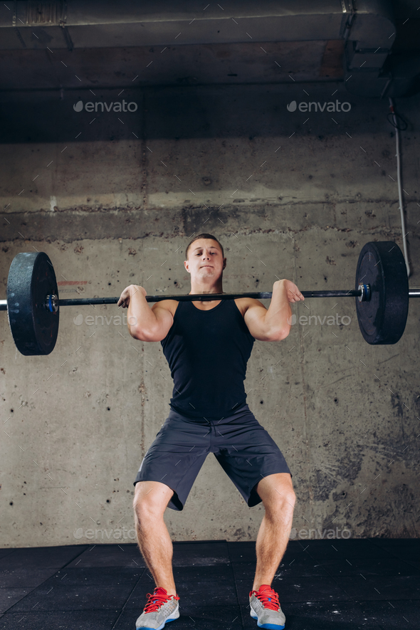 young confident bodybuilder with barbell Stock Photo by Albertshakirov
