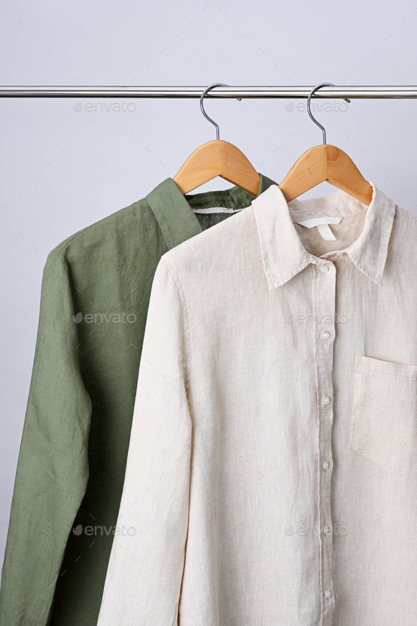Linen shirts hanging on wooden hangers Stock Photo by annakhomulo ...