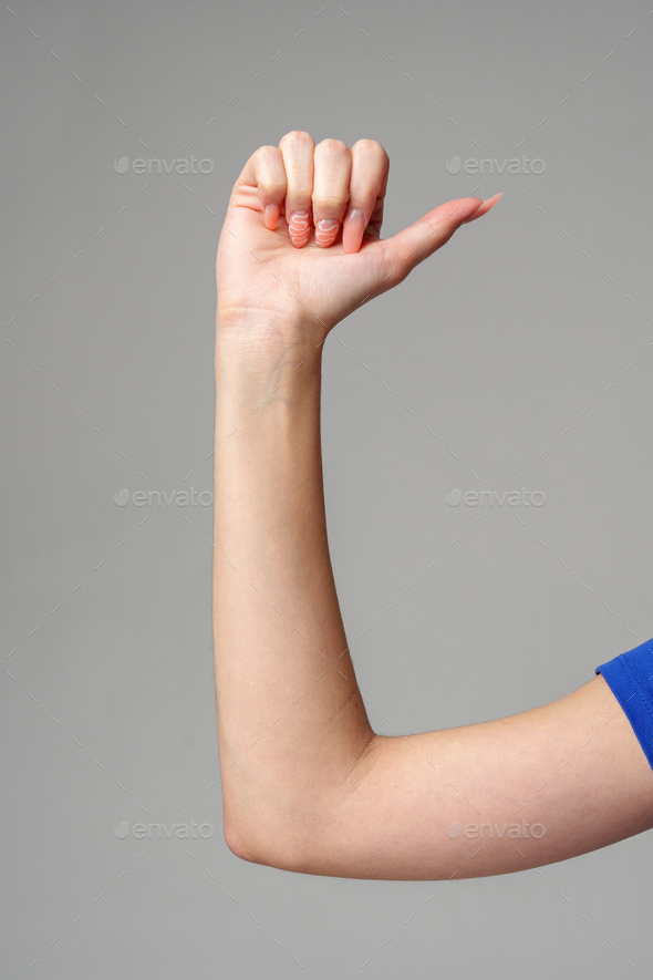 Female hand sign against gray background in studio Stock Photo by ...