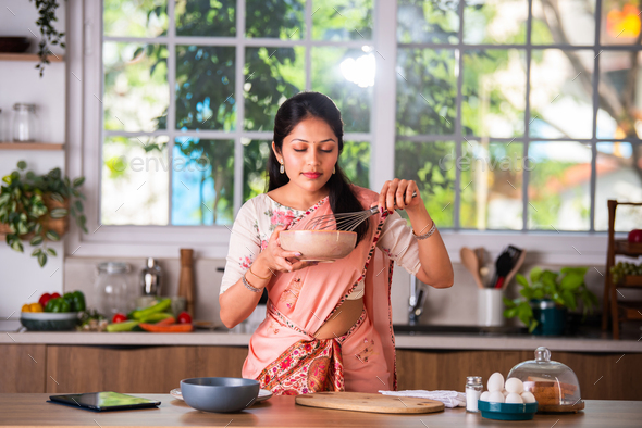 Portrait of happy Indian asian young woman wears saree while working in ...