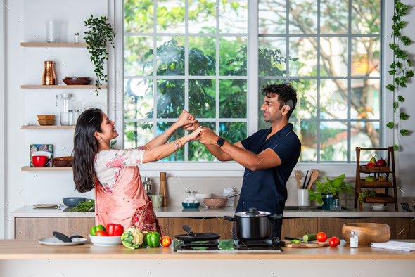 Indian asian young couple dancing in kitchen between cooking meal Stock ...