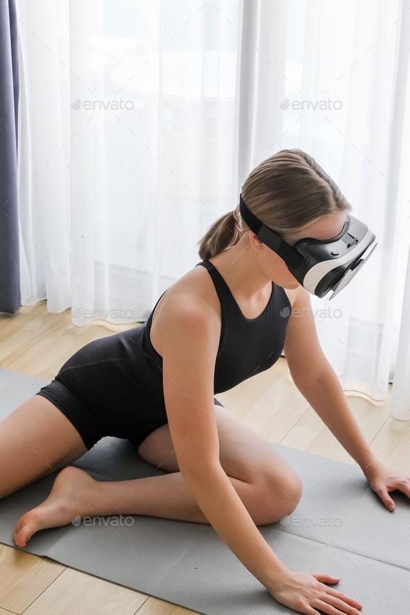 VR fit.Girl doing fitness in VR glasses at home,virtual reality exercise, immersive workout,VR ...