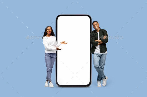 Two people flanking a digital mockup screen Stock Photo by Prostock-studio