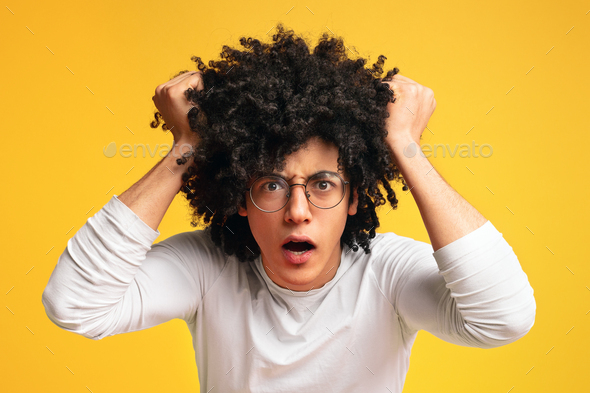 Emotional black guy shouting and rending his hair in stress Stock Photo ...