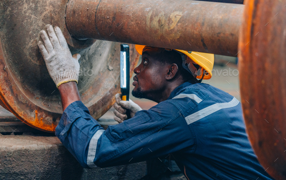 Rail technician inspects train wheels with flashlight for faults and ...