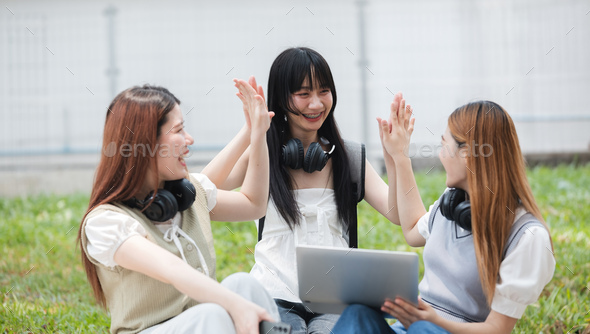 Group Of Young Asian Students Collaborating Outdoors at University ...