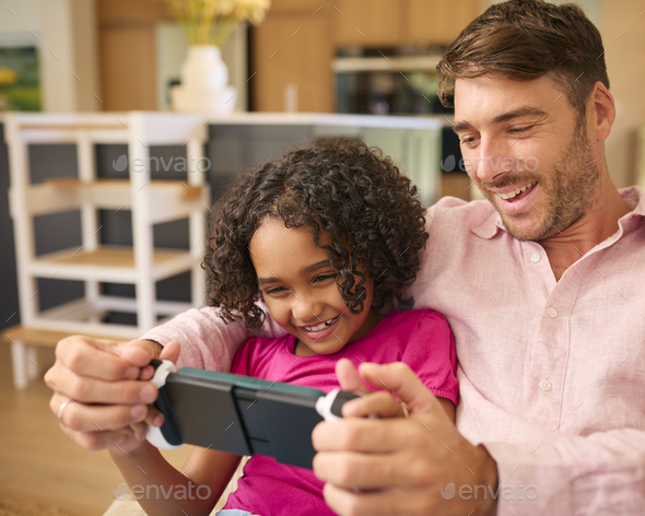 Multi Racial Family With Father And Daughter Playing On Handheld Gaming ...