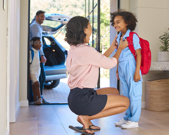 Family At Home With Parents Getting Children Ready To Leave House And ...
