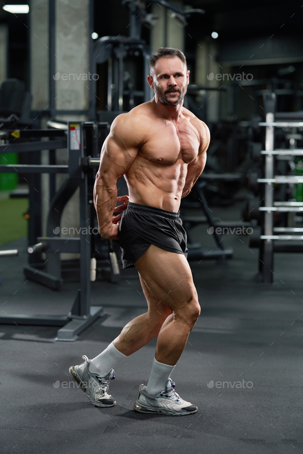 Tanned bodybuilder demonstrating side triceps pose. Stock Photo by ...