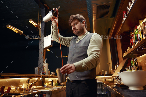 Bartender mixing cocktail using traditional shaking cups Stock Photo by ...