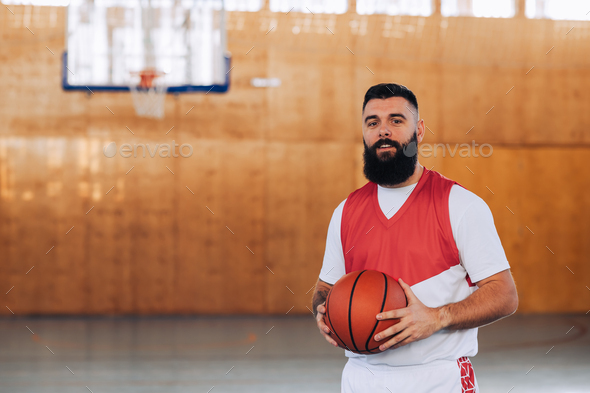 Portrait of a bearded caucasian male basketball player with a ball in ...