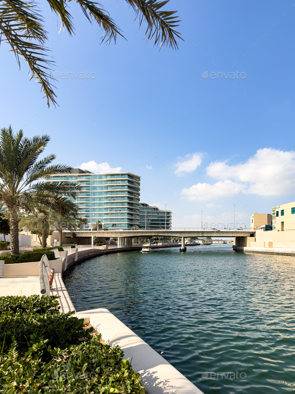 Apartment buildings and water canal in the Al Raha Beach neighbourhood ...