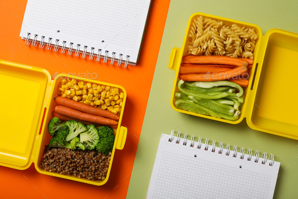 Yellow lunch box with healthy food and notebooks Stock Photo by ...