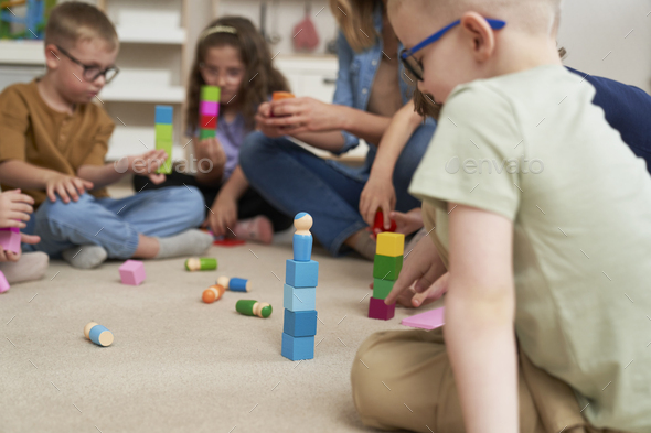 Children using toy block for sensory exercises Stock Photo by gpointstudio