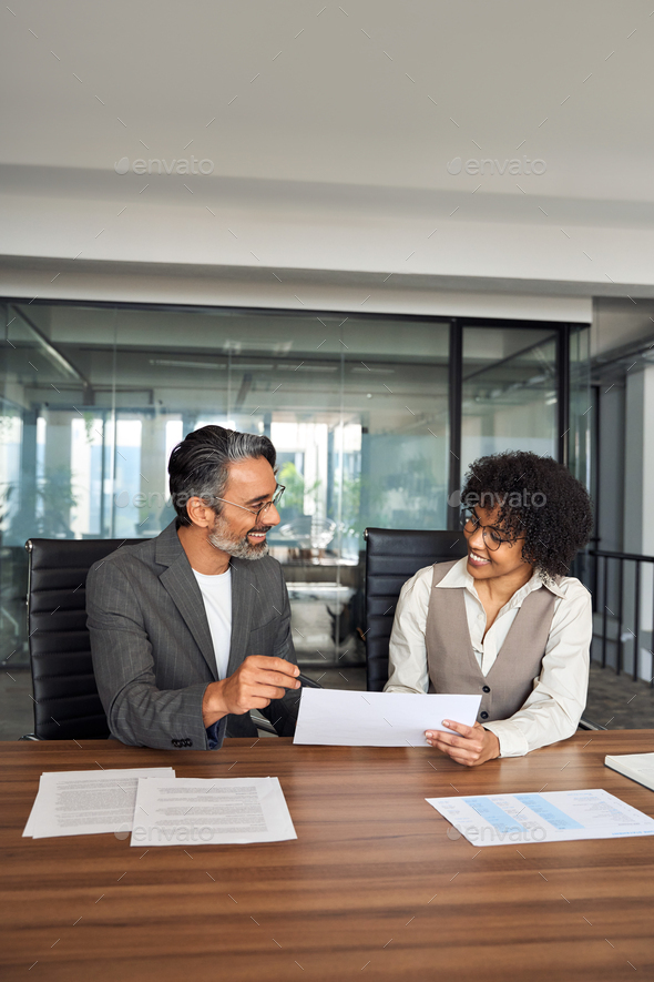 African female financial advisor consulting client investor at meeting ...