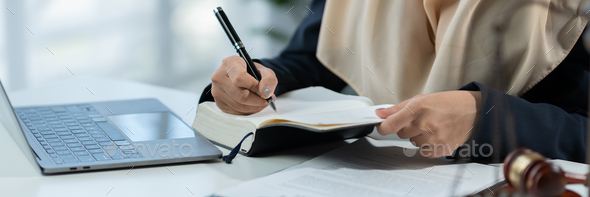 Muslim woman lawyer wearing hijab asian, legal advisor, taking note and ...