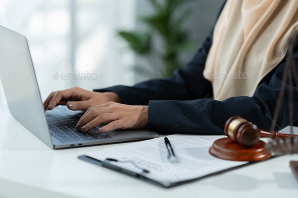 female lawyer Muslim wearing hijab working on business contract ...