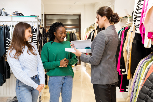 Happy Customers Shopping at Clothing Store with Salesperson Stock Photo ...