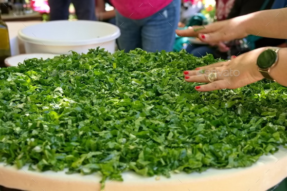Preparing soparnik - traditional Croatian food dough, mangel, garlic ...