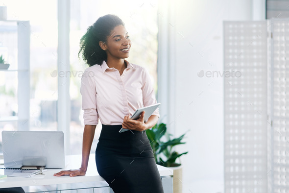 She manages all tasks with smart tech Stock Photo by YuriArcursPeopleimages