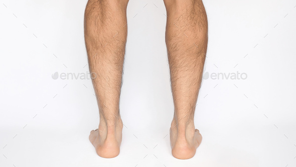 Adult male feet seen from behind observing Achilles heels and calves ...