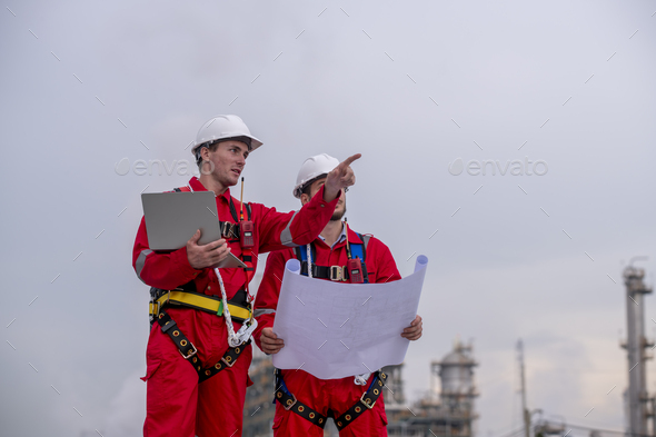 Engineer survey team wear uniform and helmet stand workplace checking ...