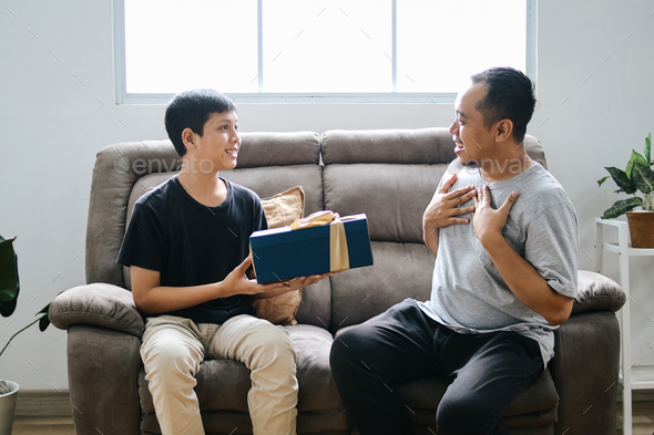 Young Boy Surprising Father Celebrating Father's Day Stock Photo by ...
