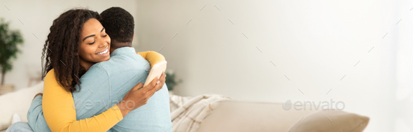 Couple hugging with love and affection, woman using phone Stock Photo ...