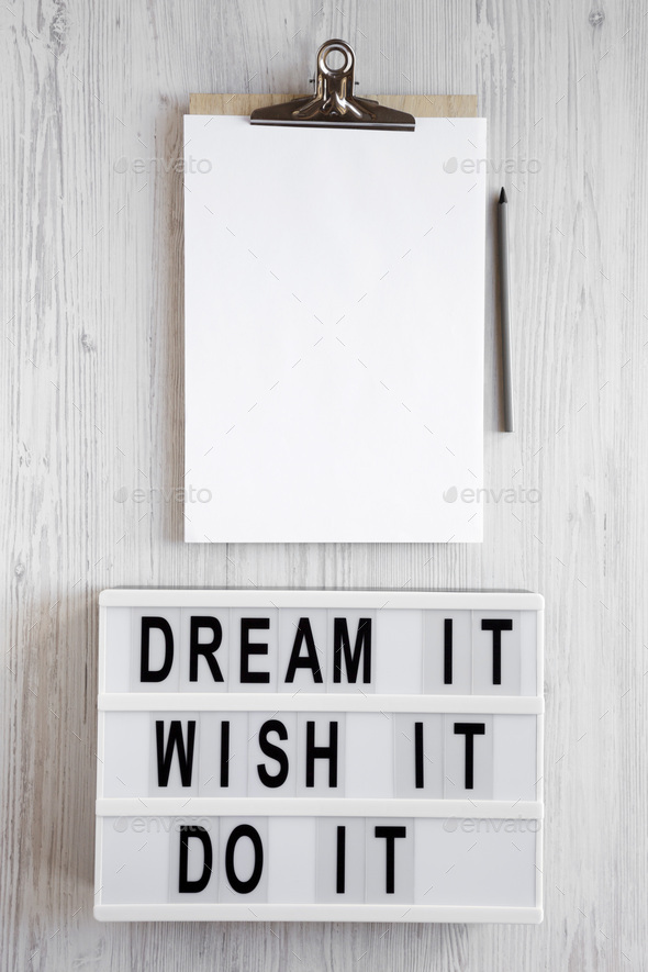 'Dream it, wish it, do it' words on a lightbox, clipboard with blank ...