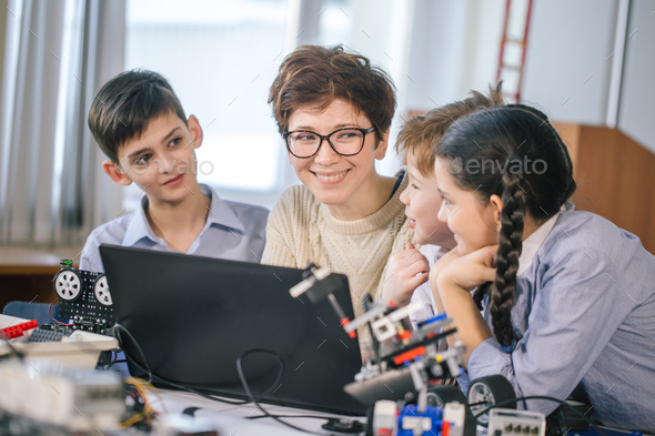 Happy children learn programming using laptops on extracurricular ...