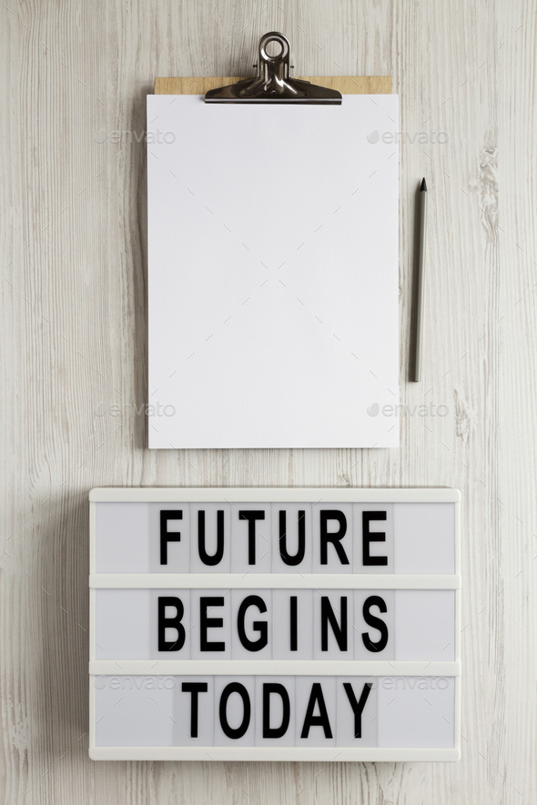 'Future begins today' words on a modern board, clipboard with blank ...
