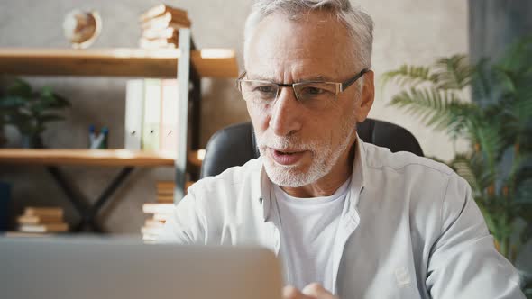 Grayhaired Man Saying Hello to Coworker Using Online Video Call on ...