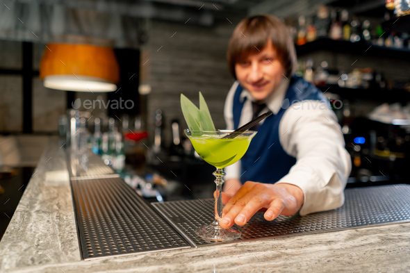 in a Japanese restaurant the bartender stands on the bar counter ...