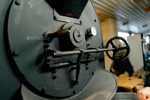 close-up at coffee roasting factory you can see how the coffee rotates ...