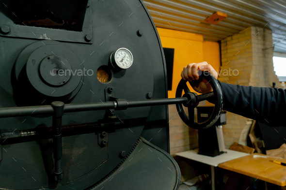 close-up at coffee roasting factory you can see how the coffee rotates ...