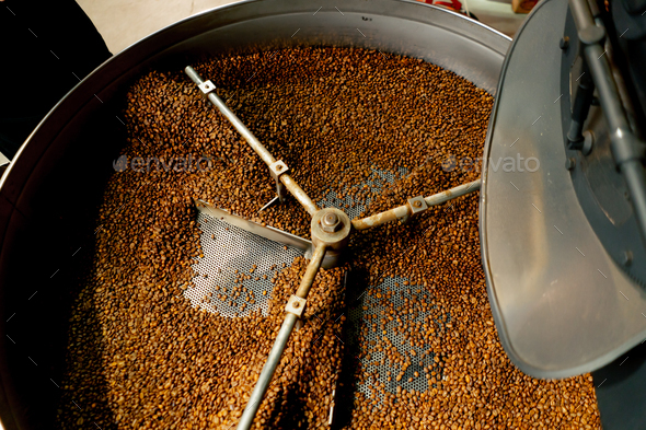 top shot close-up of a coffee roasting factory inside drum roasting ...