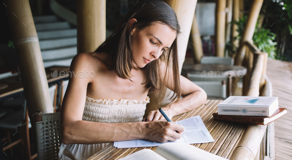 Serious woman taking notes and studying Stock Photo by GaudiLab | PhotoDune