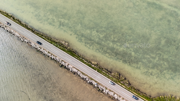 Scenic coastal road with cars driving alongside the ocean Stock Photo ...