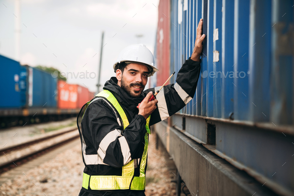 Supervisor inspecting inventory or task information on freight train ...