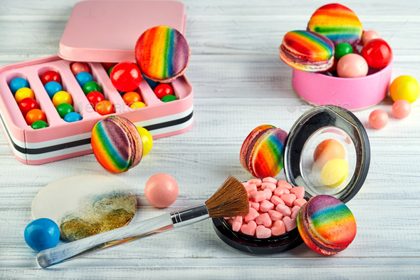 there are many different types of rainbow macaron, candy on the table ...