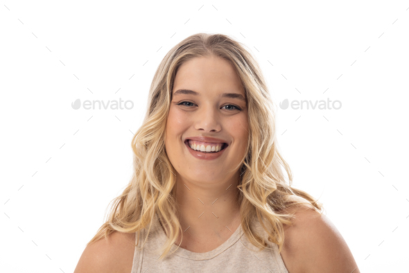 Caucasian young female plus size model smiles on white background, copy ...