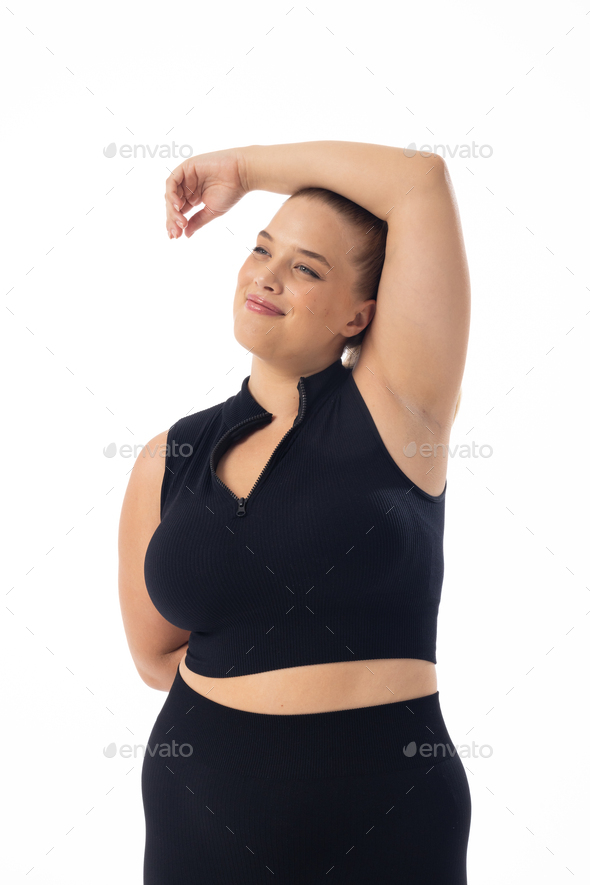 Caucasian young female plus size model poses on white background, copy ...