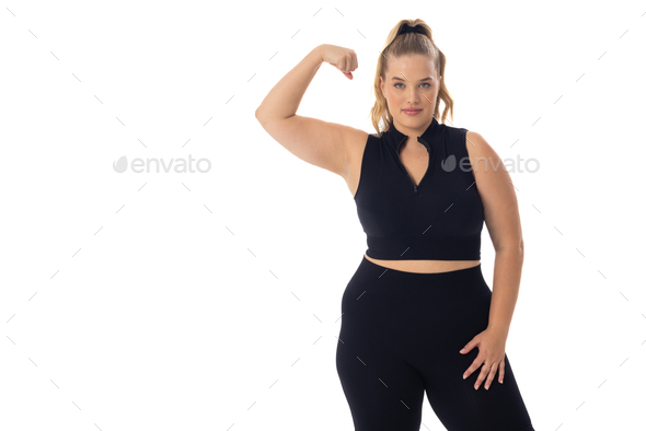 Caucasian plus size young female model flexing arm on white, showing ...
