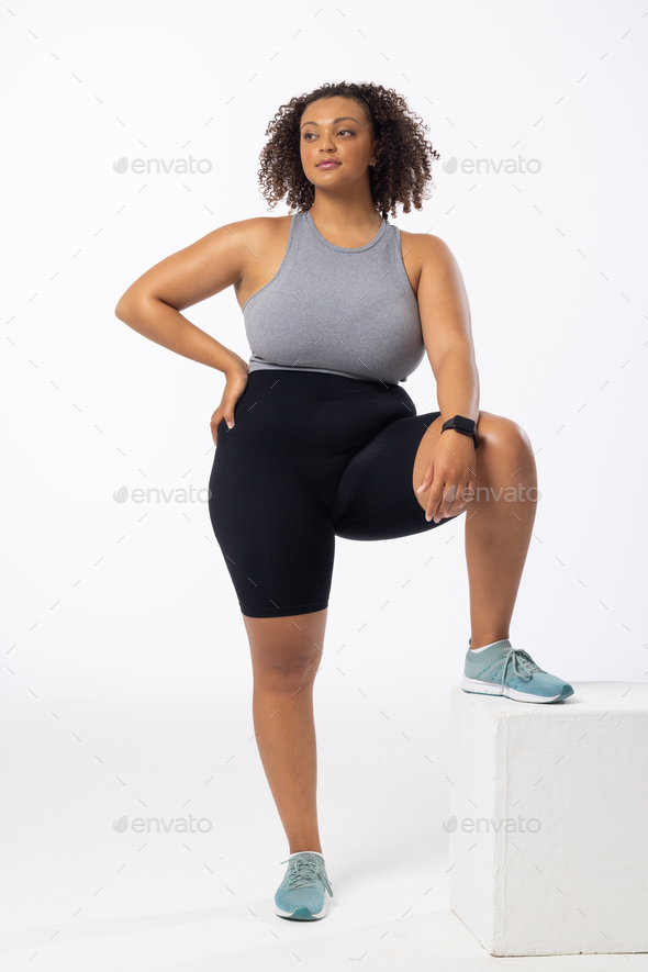 Biracial young female plus size model poses on white background Stock ...