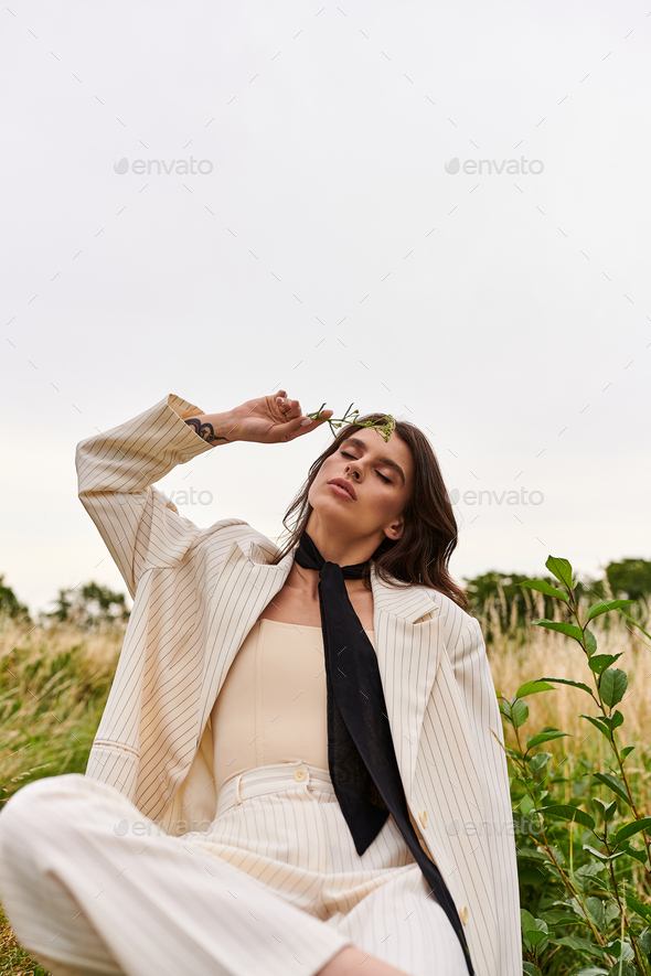 Serenity unveiled: woman embracing nature Stock Photo by LightFieldStudios