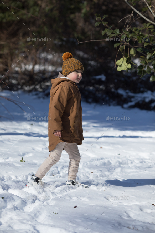 outdoor winter portrait of boy face in the snow. Authentic, real ...